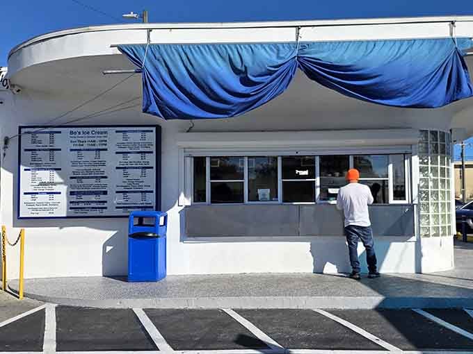 The menu board promises sweet decisions while those blue drapes add vintage charm to your cone-hunting adventure today.