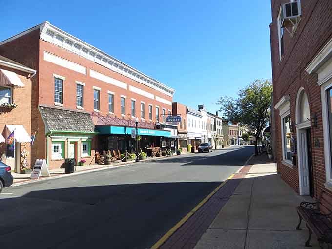 Sunny skies illuminate Cambridge's charming main street, where vintage architecture meets modern small-town life beautifully.