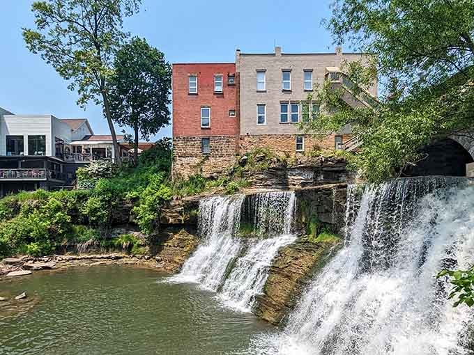 The layered rock formations create a natural staircase as water tumbles through the heart of town.