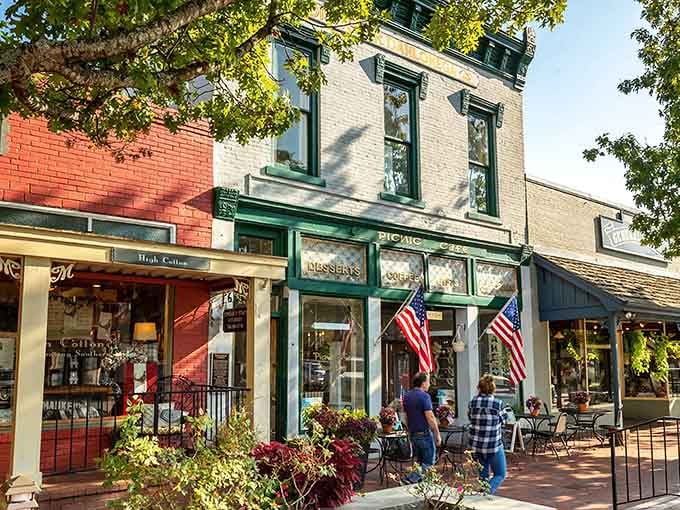 Outdoor dining and patriotic flags frame this classic Main Street scene that feels like stepping into Mayberry.