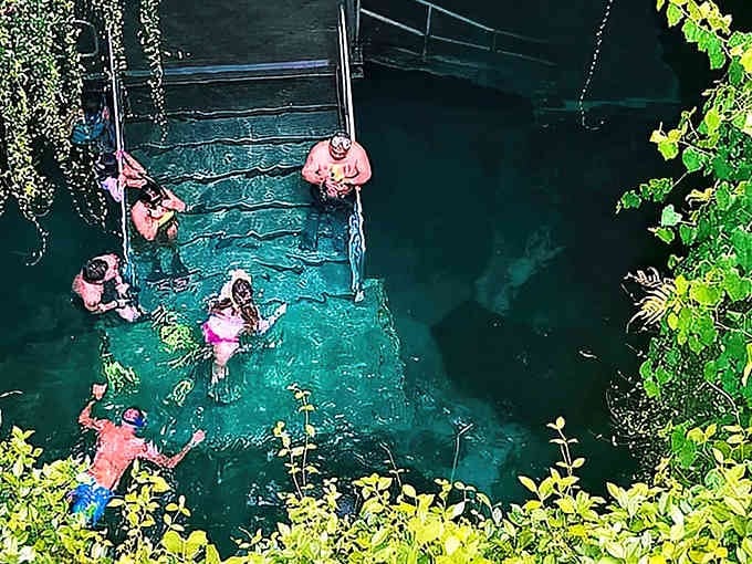 Swimming in this prehistoric spring means sharing space with history, stalactites dripping overhead like nature's chandeliers.