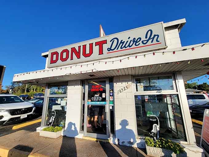 Classic drive-in architecture meets modern donut cravings under a perfect blue sky that says "good morning."