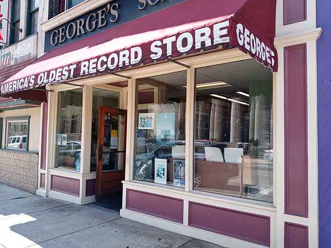 Those classic storefront windows frame vinyl treasures like a museum display for music lovers passing by.