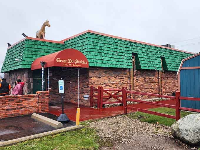 The weathered brick wall and wooden fence create an authentic stable atmosphere without the hay smell.