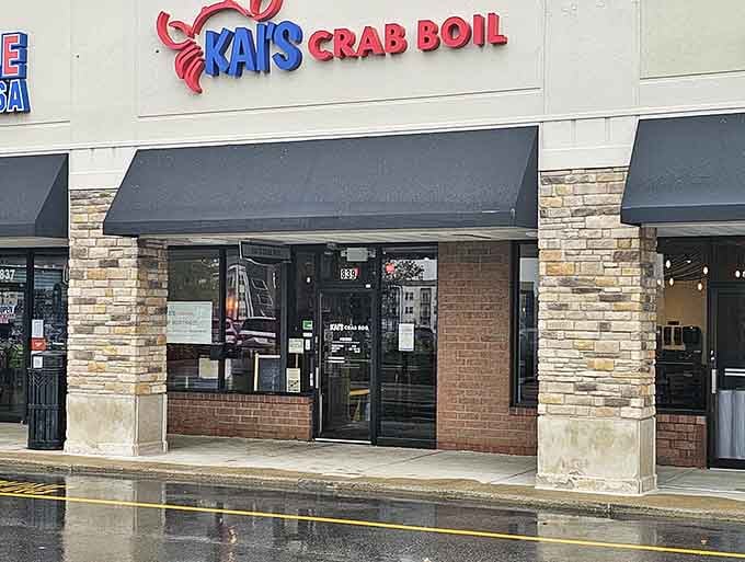 Rain-slicked pavement reflects the promise of coastal flavors hiding behind those welcoming glass doors ahead.