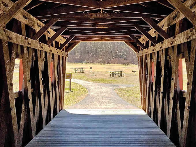 Step through this charming covered bridge and discover picnic spots framed by trees and timeless New England beauty.