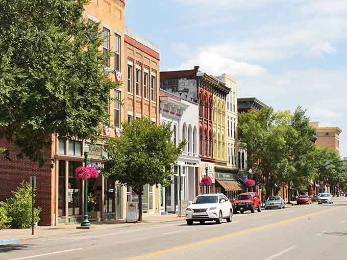 Tree-lined streets frame historic buildings where every awning tells a story about river town commerce and community.