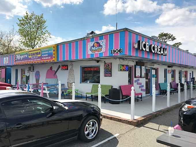 Rainbow chairs lined up like a welcoming committee, ready to host your next sweet summer memory.