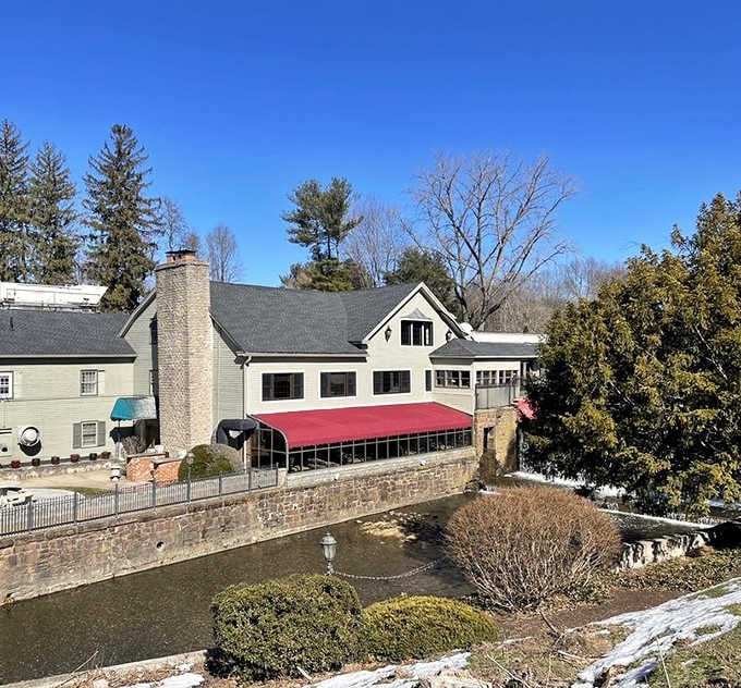 That red awning beckons like a lighthouse, guiding hungry souls to riverside dining perfection year-round.