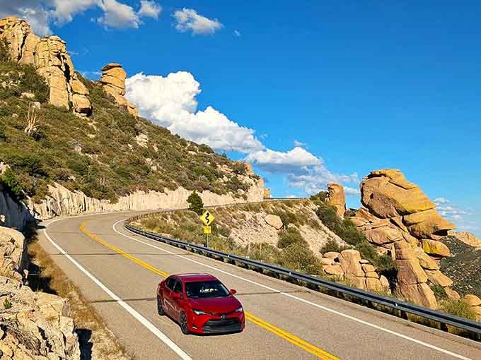When the road curves through towering stone pillars under cotton-candy clouds, you know you've found something truly special.