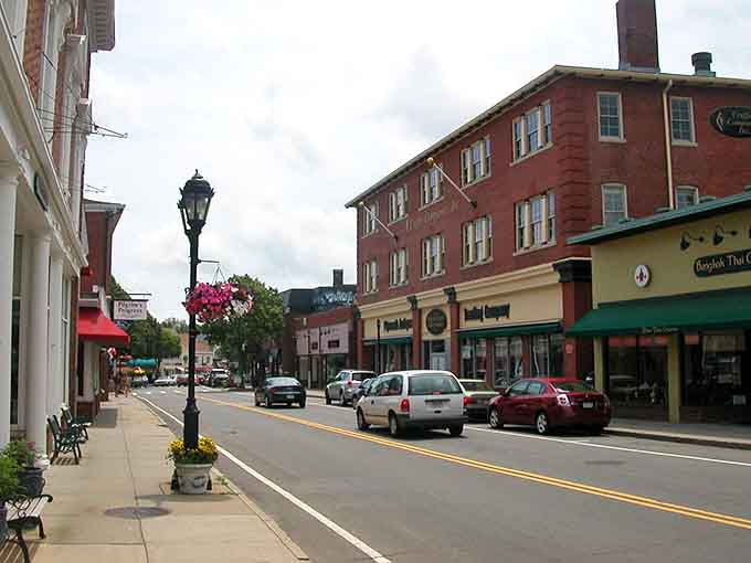 Those vintage lampposts and brick storefronts whisper stories from centuries past while locals grab their morning coffee today.