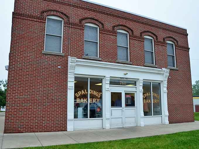 Those arched windows above tell stories while the bakery below creates sweet memories every single morning.