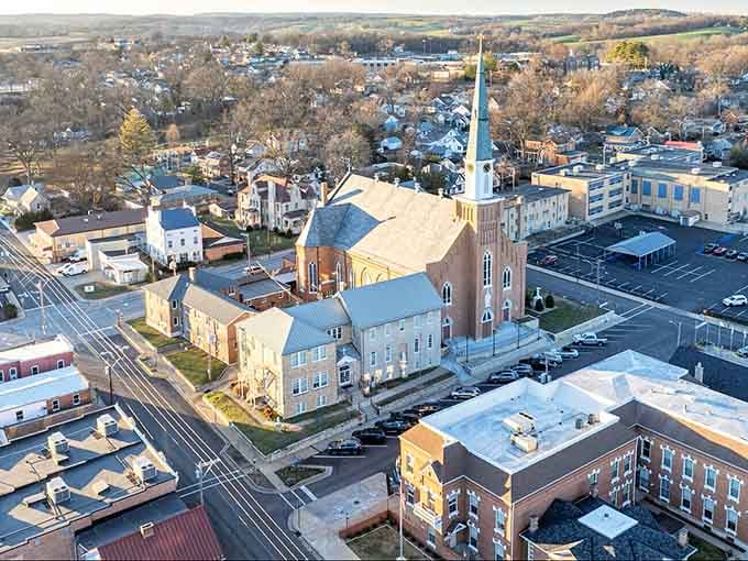 From above, church steeples pierce the sky while historic rooftops create a patchwork of American heritage below.