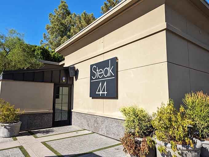 Clean lines and desert landscaping create an inviting entrance where great beef awaits inside.