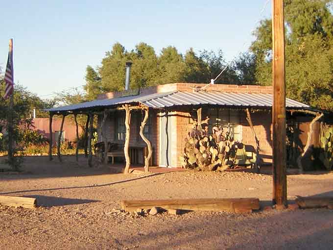 That rustic adobe structure with prickly pear cacti tells stories of frontier life under golden desert light.