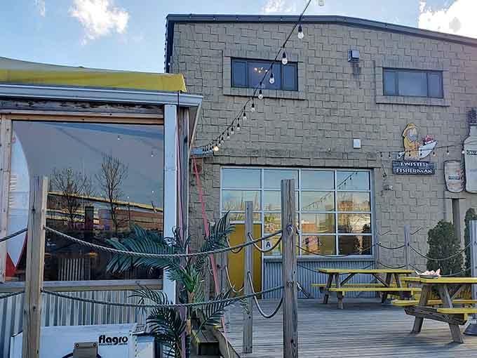 Relax on this sunny wooden deck, where bright yellow picnic tables and festive string lights invite you to savor every bite.