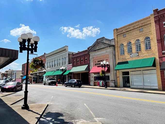 Those vintage streetlamps and colorful awnings create a Main Street that looks like it stepped out of a postcard.