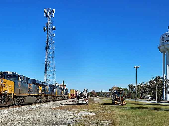 That water tower stands tall like a proud sentinel, watching over tracks that have carried stories for generations.