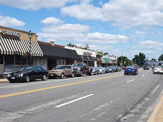 Those striped awnings and parked cars tell you this is a downtown where people actually enjoy spending time.