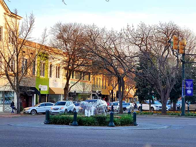 Downtown Aiken glows at twilight, where locally-owned shops outnumber chain stores and neighbors still wave from their storefronts.