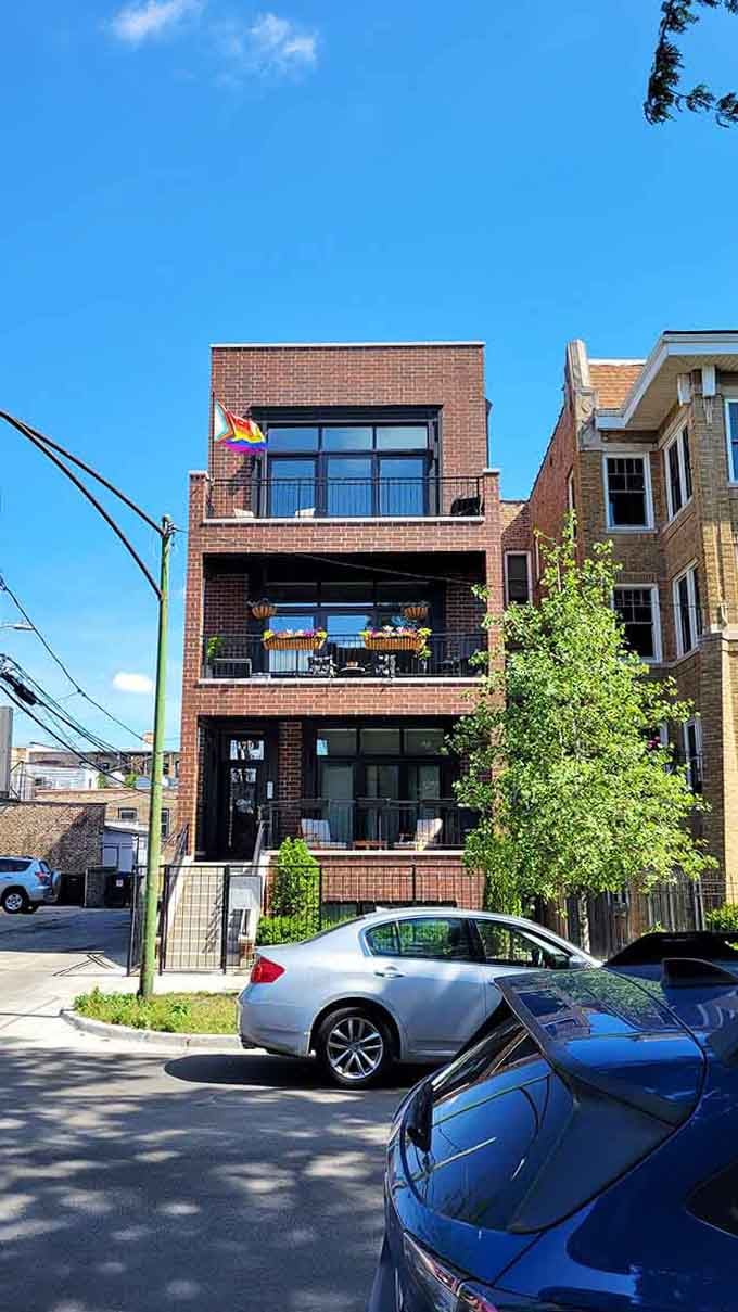 Rainbow flags and flower boxes prove that pride and curb appeal aren't mutually exclusive in this neighborhood.