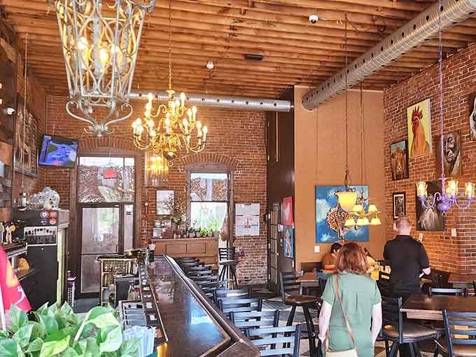 Exposed brick, glowing chandeliers, and colorful art create an atmosphere that's equal parts sophisticated and welcoming.