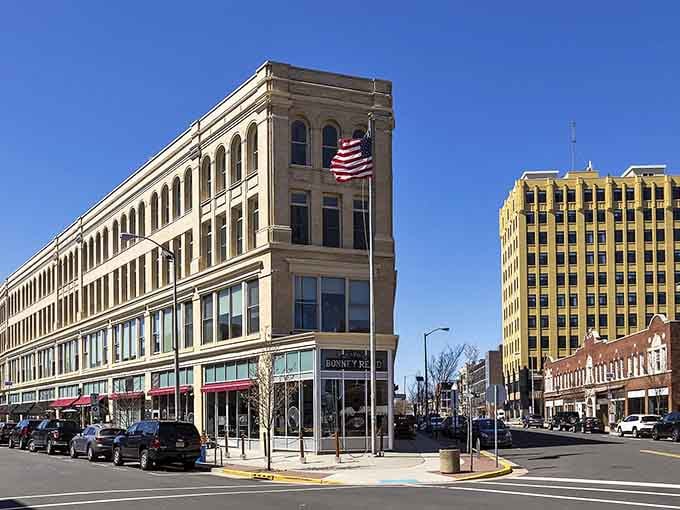 That American flag draped on historic brick says everything about pride, perseverance, and a town that honors its past.