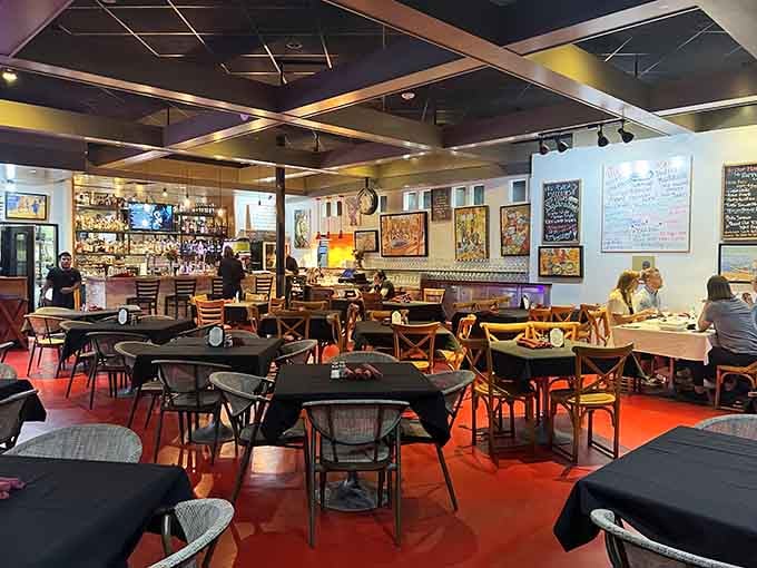 Bold red floors and warm lighting create an atmosphere where comfort food meets continental sophistication beautifully.