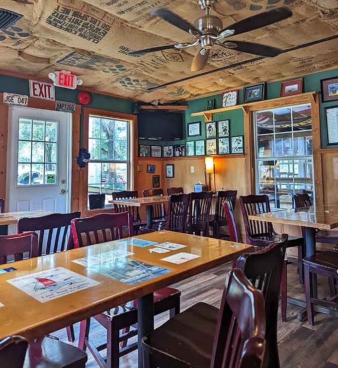 Vintage signs and license plates create a cozy roadhouse vibe where comfort food meets genuine Southern hospitality daily.