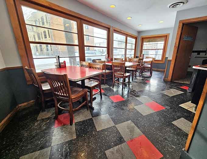 Checkerboard floors and sunlit windows create the kind of atmosphere where time slows down and conversations linger.