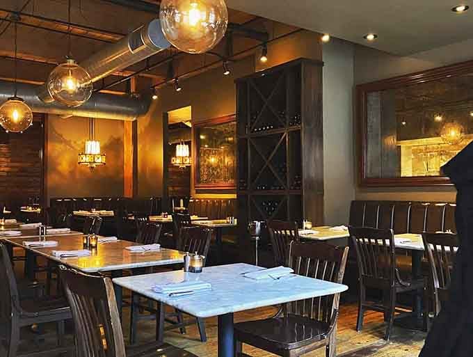 Industrial chic meets Italian warmth in a space where exposed brick and marble tables create dining magic.