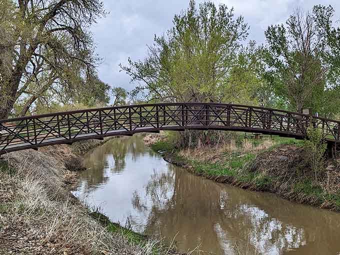 This charming bridge over calm waters proves that sometimes the journey really is as beautiful as the destination.