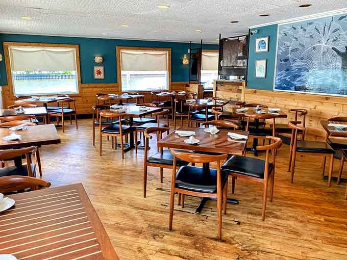 Clean lines, warm wood, and that perfect teal accent wall create an inviting space for serious eating.