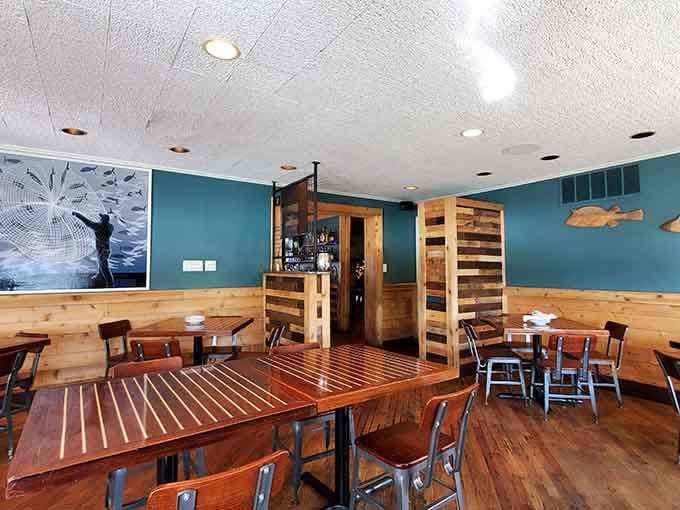 Teal walls and wooden tables create a vibe that's part beach house, part fishing lodge, all comfort and charm.