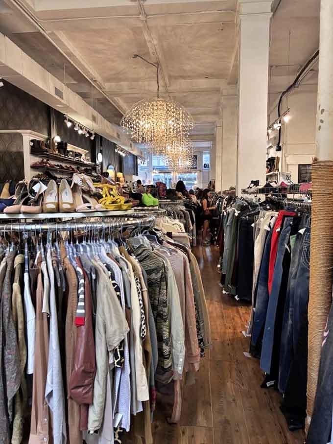 Sparkling chandeliers illuminate racks of possibilities, proving thrift stores can have more ambiance than most department stores.