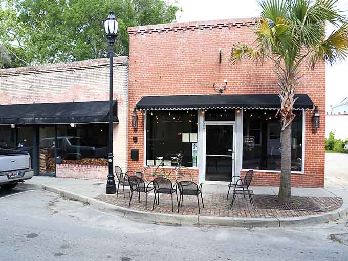 That brick storefront with sidewalk seating whispers "stay awhile" louder than any billboard ever could.