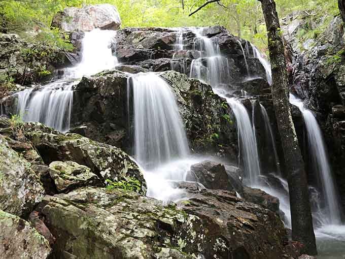 Each tier tells a billion-year story as water dances over dark rhyolite like nature's own fountain show.
