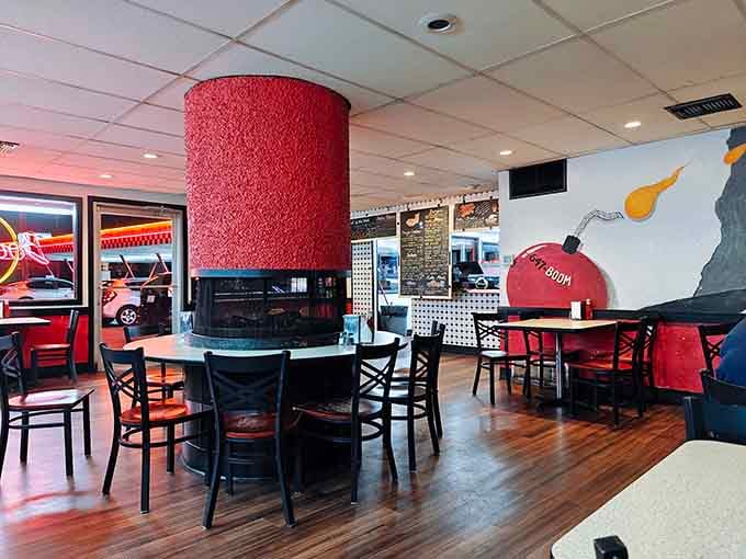 The circular fireplace anchors this retro dining room where burgers meet mid-century charm in perfect harmony.