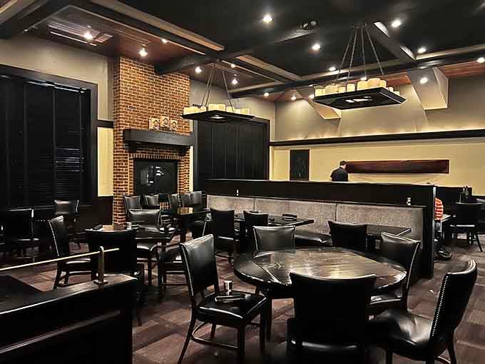 Dark leather, warm lighting, and that fireplace create an ambiance that says "special occasion" without requiring a tuxedo.