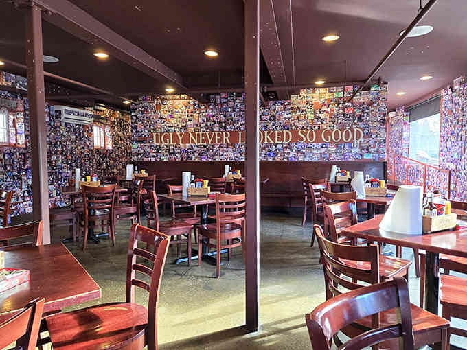 Photo-covered walls tell a thousand stories of burger conquests, each face immortalized in their moment of glory.
