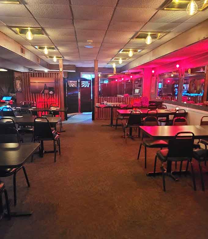 Red lighting and cozy chairs create the perfect atmosphere for savoring steaks and making memories with friends.