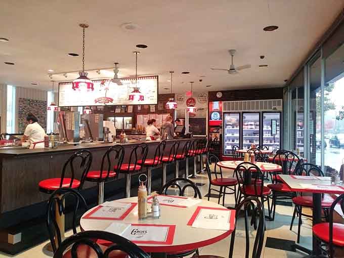 Red vinyl, chrome fixtures, and checkered floors create a time machine you can actually sit in.