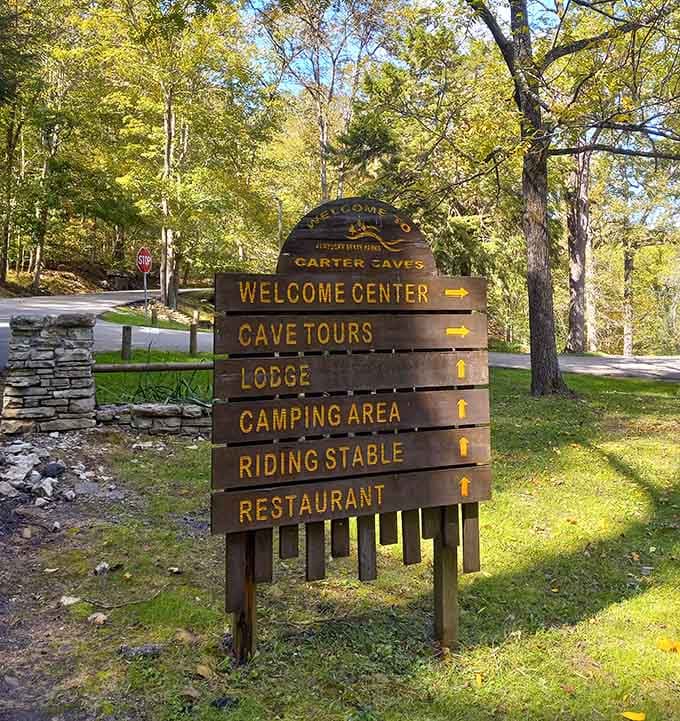 Every great adventure starts with a sign, and this one promises caves, camping, and comfort food all in one place.
