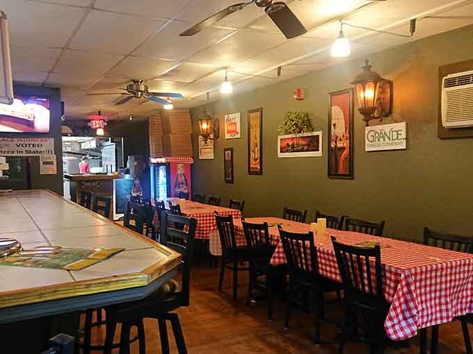 Those checkered tablecloths and warm lighting create the kind of cozy Italian atmosphere that makes every meal feel special.