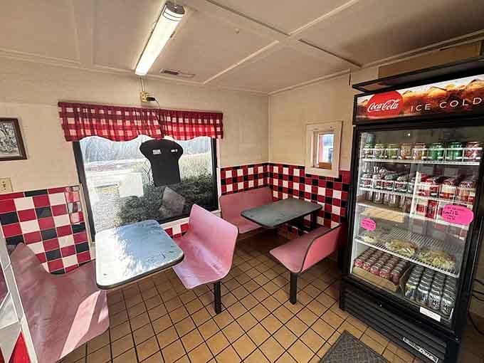 Red and white checkered charm meets no-nonsense comfort in this cozy dining room where pizza dreams come true.