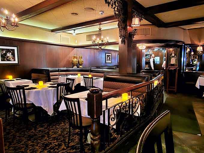 Dark wood, white linens, and warm lighting create an atmosphere that whispers "celebration" without shouting it.