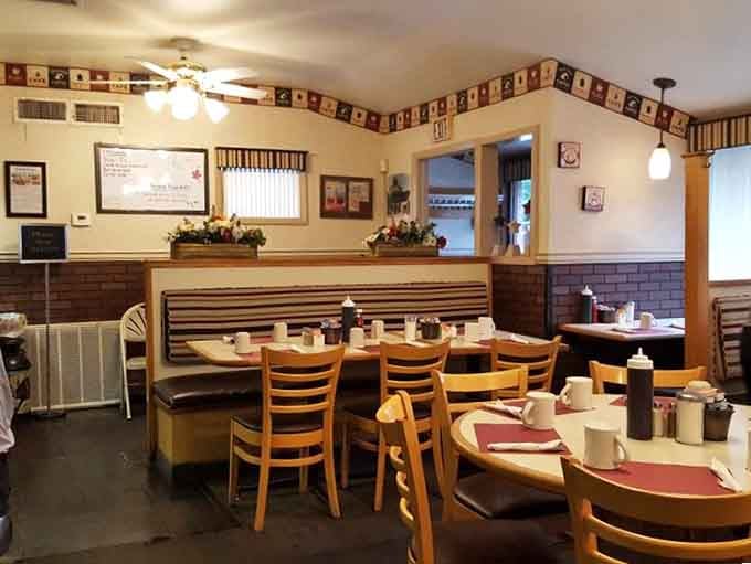 Cozy booths, warm lighting, and tables set for breakfast lovers create the perfect neighborhood gathering spot.