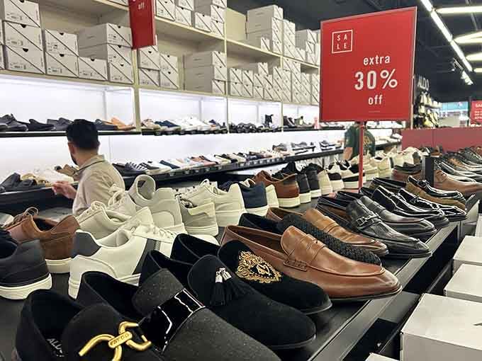 Rows of shoes stretching into infinity, like a footwear lover's fever dream, with discounts that make impulse buying feel like financial responsibility.