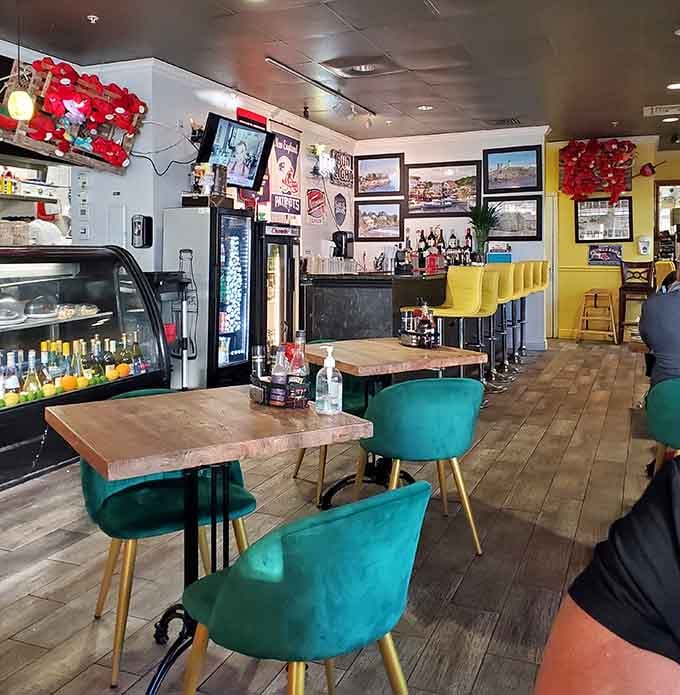 Those turquoise velvet chairs and yellow bar stools create a vibe that's part beach house, part Boston harbor hangout.
