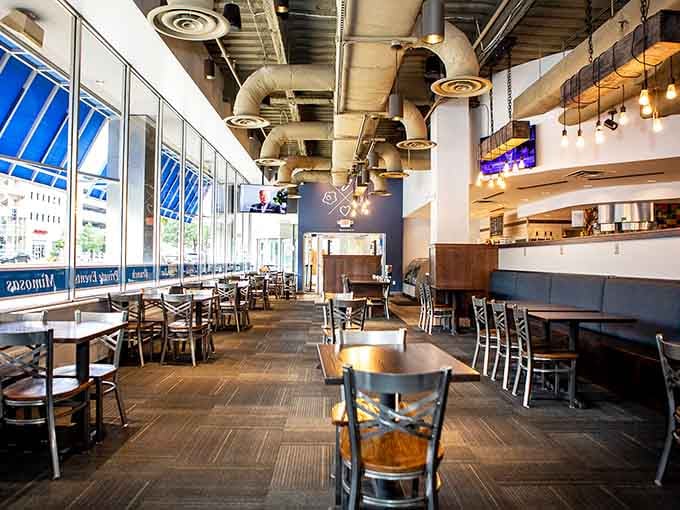 Floor-to-ceiling windows and soaring ceilings create a space where morning light dances across every table beautifully.